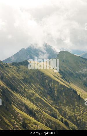 Mystical mountain landscape with thunder clouds and fog in cloudy ...