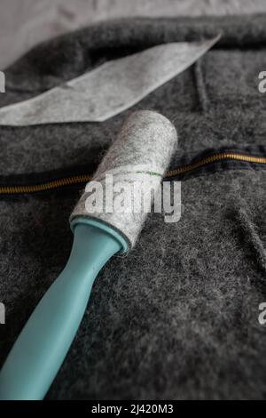 Lint roller on color background Stock Photo - Alamy