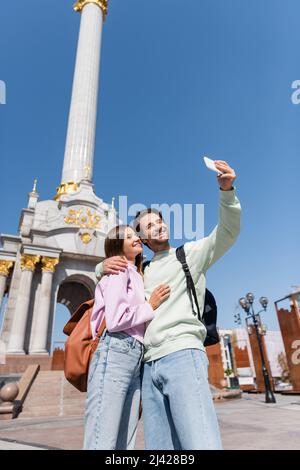 KYIV, UKRAINE - SEPTEMBER 1, 2021: Smiling couple taking selfie on ...