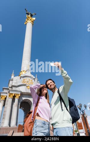 KYIV, UKRAINE - SEPTEMBER 1, 2021: Smiling couple taking selfie on ...