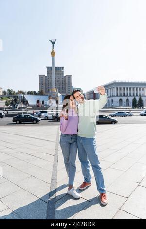 KYIV, UKRAINE - SEPTEMBER 1, 2021: Smiling couple taking selfie on ...