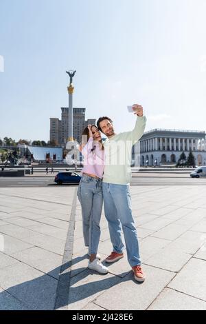 KYIV, UKRAINE - SEPTEMBER 1, 2021: Smiling couple taking selfie on ...