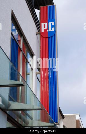 Peek & Cloppenburg, facade with sign and logo, illuminated, reflection ...