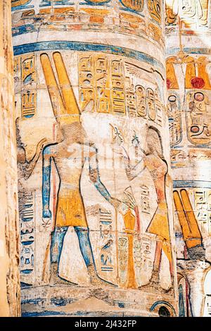 hieroglyphs and drawings of pharaohs carved in sandstone column in ...