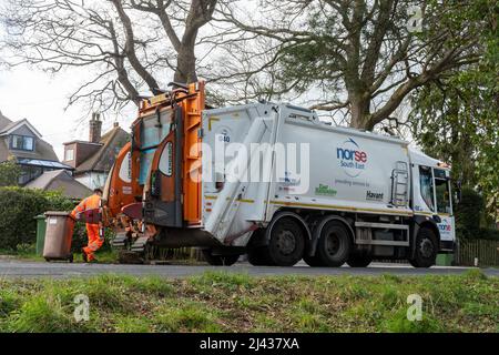 Waste rubbish or trash lorry or truck lifting green bin with man in ...