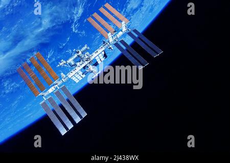 ISS over the planet, against the background of clouds. Elements of this ...