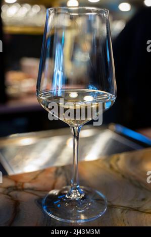 Glass of cold dry Italian pinot grigio white wine served in Italian bar ...