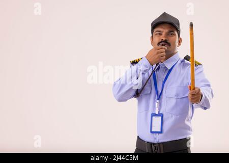 Portrait of Security guard blowing whistle with stick in his hand Stock ...