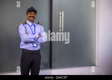 Portrait of security guard with arms folded Stock Photo - Alamy