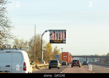 warning matrix sign on gantry with "oncoming vehicle "and 20 mph speed ...