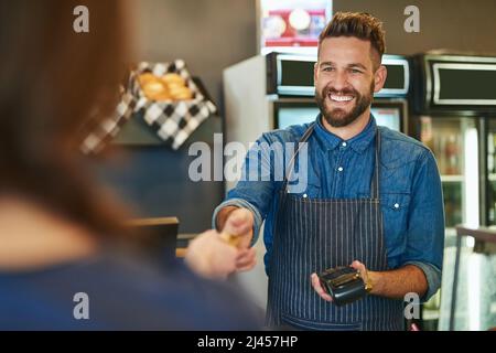 cropped shot of waiter holding payment terminal while smiling woman ...
