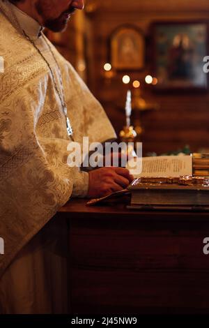 Priest reading sacred book in front of temple Stock Photo - Alamy