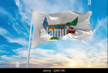 flag of Hidalgo , Mexico at cloudy sky background on sunset, panoramic ...
