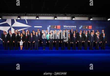 Participants of the NATO summit pose for a group photo in Warsaw Stock ...
