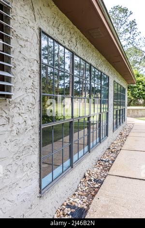 The side view of a brown 1970's ranch style spanish style villa stucco ...