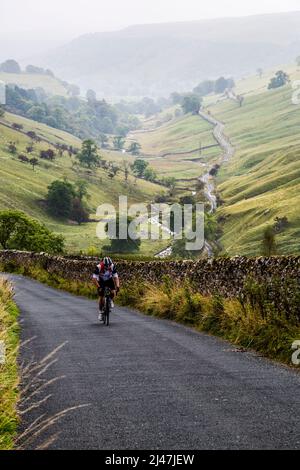 UK, England. Bicycle Rider Climbing Steep Hill on an Autumn Day in the ...