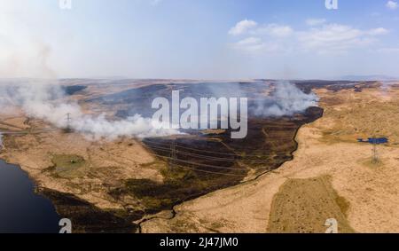 Aerial view of a huge wildfire on higher level moorland next to a ...
