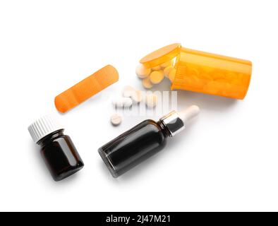 Bottles with iodine, medical plaster and container with pills on white ...