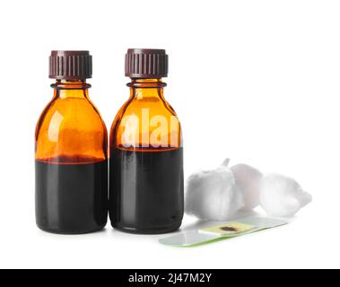 Bottles with iodine, medical plaster, cotton swab and gauze roll on red ...