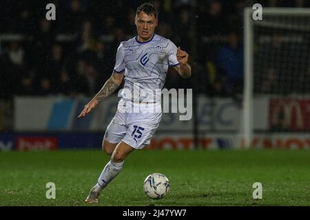 Jason Kerr #15 of Wigan Athletic attempts to collect a cat that has ...