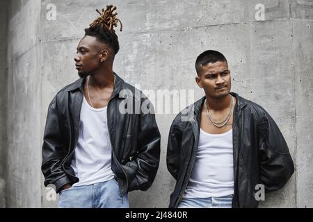 two young handsome african brothers studying their book against ...