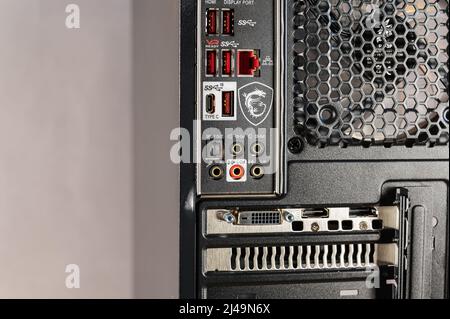 The back of a personal computer system unit. Black case with ...