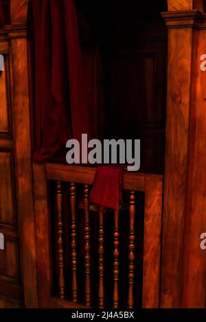 Old fashioned empty confessional in a church closeup architectural ...