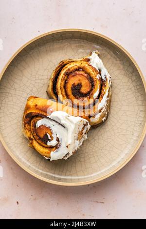 Homemade Cinnamon rolls against a pink background Stock Photo - Alamy