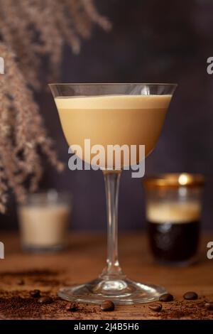 Coffee drink or cocktail with cream on a black background. Copy space ...