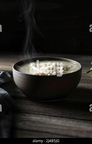Steamy bowl of Chicken Jook in a rustic kitchen Stock Photo - Alamy