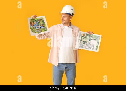 Young male landscape designer with new projects on color background ...
