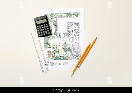Landscape designer's plan with stationery and calculator on light ...