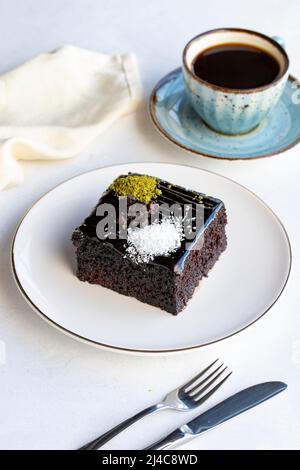 Wet cake. Pastry product. Cake with chocolate sauce on dark background ...