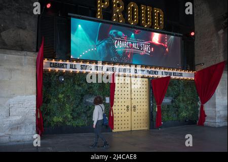 A lone woman passes Proud Embankment, a cabaret club situated under ...