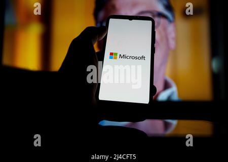 Microsoft logo on screen and Bill Gates in a background. He is a co ...