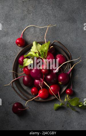 Round multi-colored radish on an old tray on a dark background Stock ...