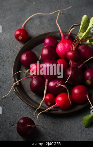 Round multi-colored radish on an old tray on a dark background Stock ...