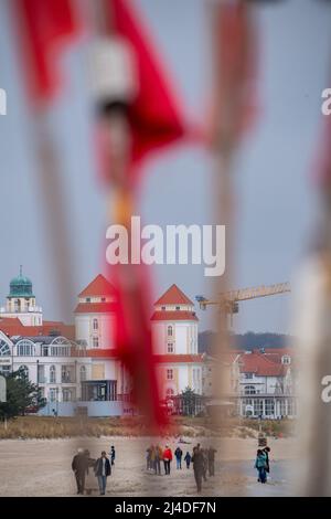 Binz, Germany. 14th Apr, 2022. Tourists walk on the beach on the pier ...