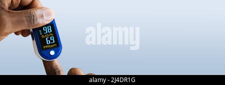African Hand Pulse Heart Rate And Oximeter Stock Photo - Alamy