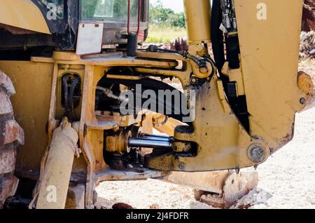 The backhoe boom, hoses, cables and cylinders that connects to the cab ...