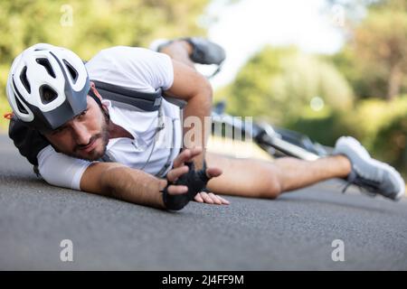 Bike injuries. Man cyclist fell off road bike while cycling. Bicycle ...