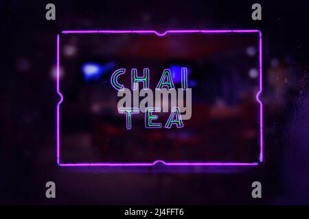 Neon Chai Tea Sign in Rainy Window Stock Photo - Alamy