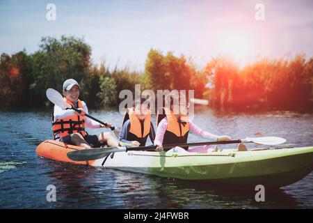 asian family sailing kayak boat in fresh water lagoon ,kayaking is one ...