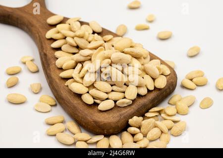 Peeled almond kernel isolated on white background. A bowl of almonds ...
