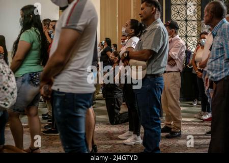 People attend the Sacrament of Eucharist Mass during the holy week ...