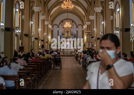 People attend the Sacrament of Eucharist Mass during the holy week ...