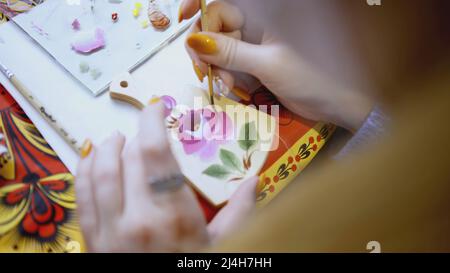 Hands weaving the bottom of a straw basket. ART. A man weaves a round ...