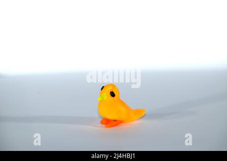 A small yellow chick. Plasticine bird on a white background Stock Photo ...