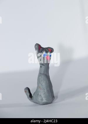 White cat of plasticine on a black background Stock Photo - Alamy
