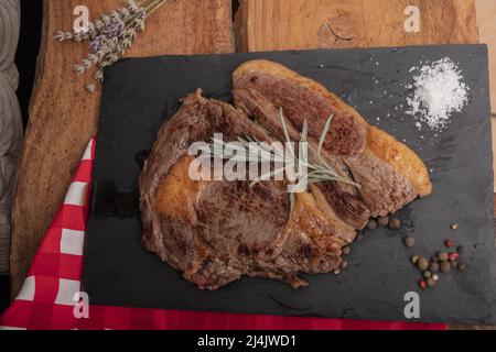Beef on a slab of dark stone Stock Photo - Alamy